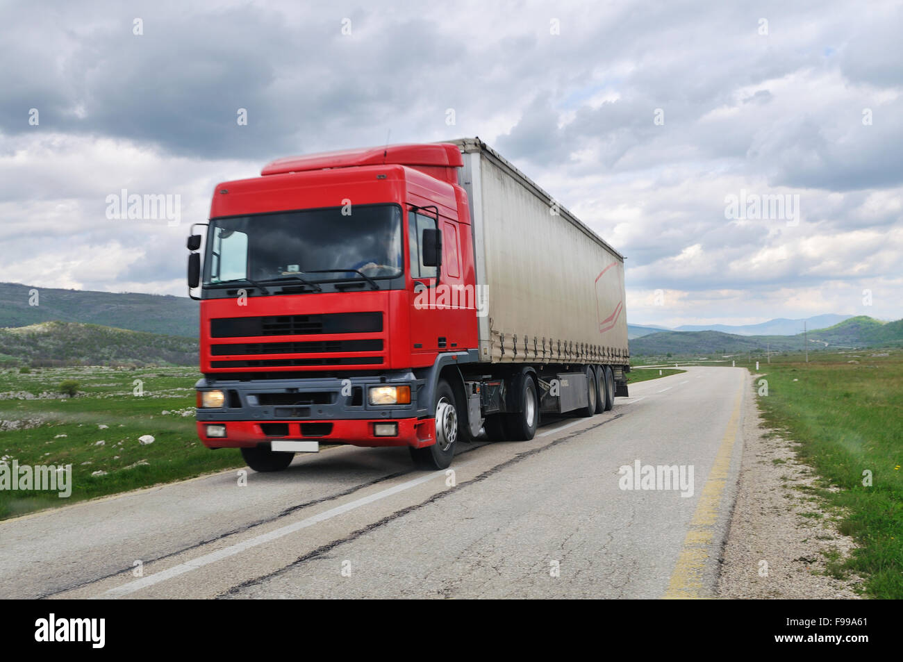 big truck drive on long country road Stock Photo - Alamy