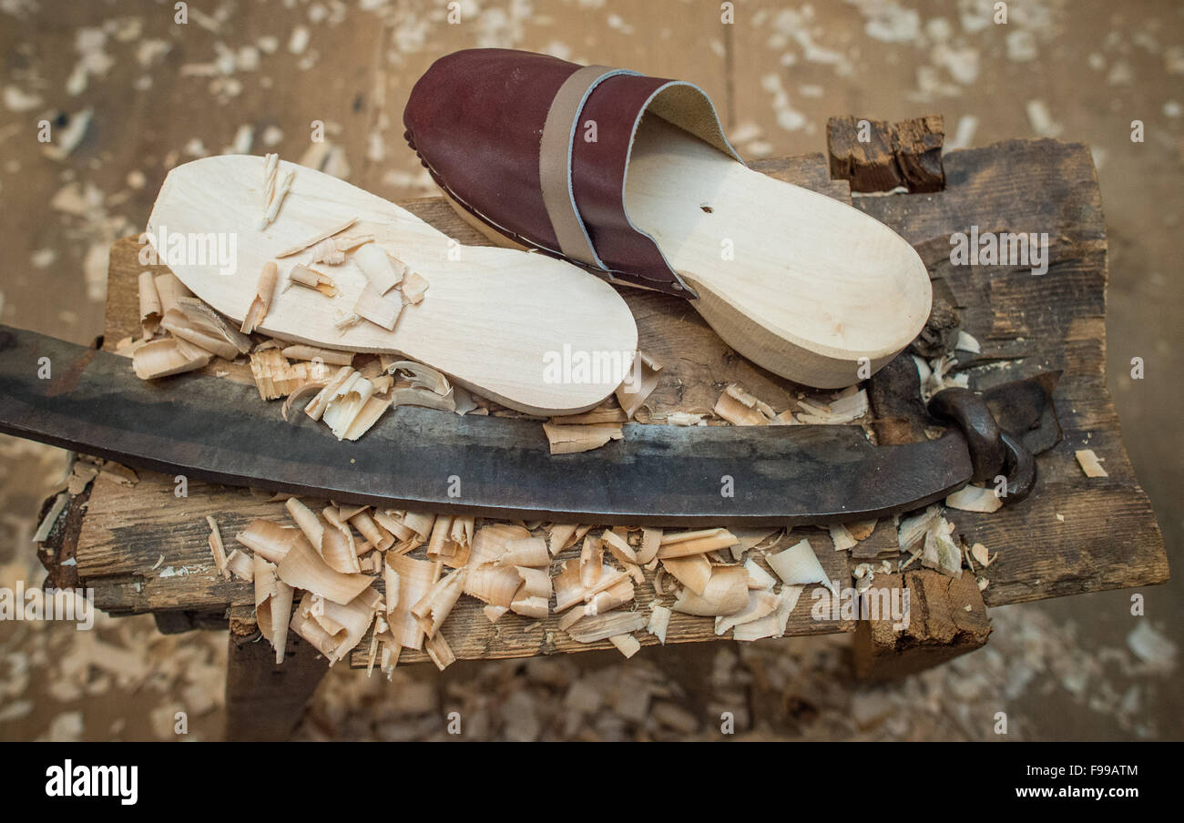 A pressure gauge, a wooden shoe bed and a finished clog in the ...