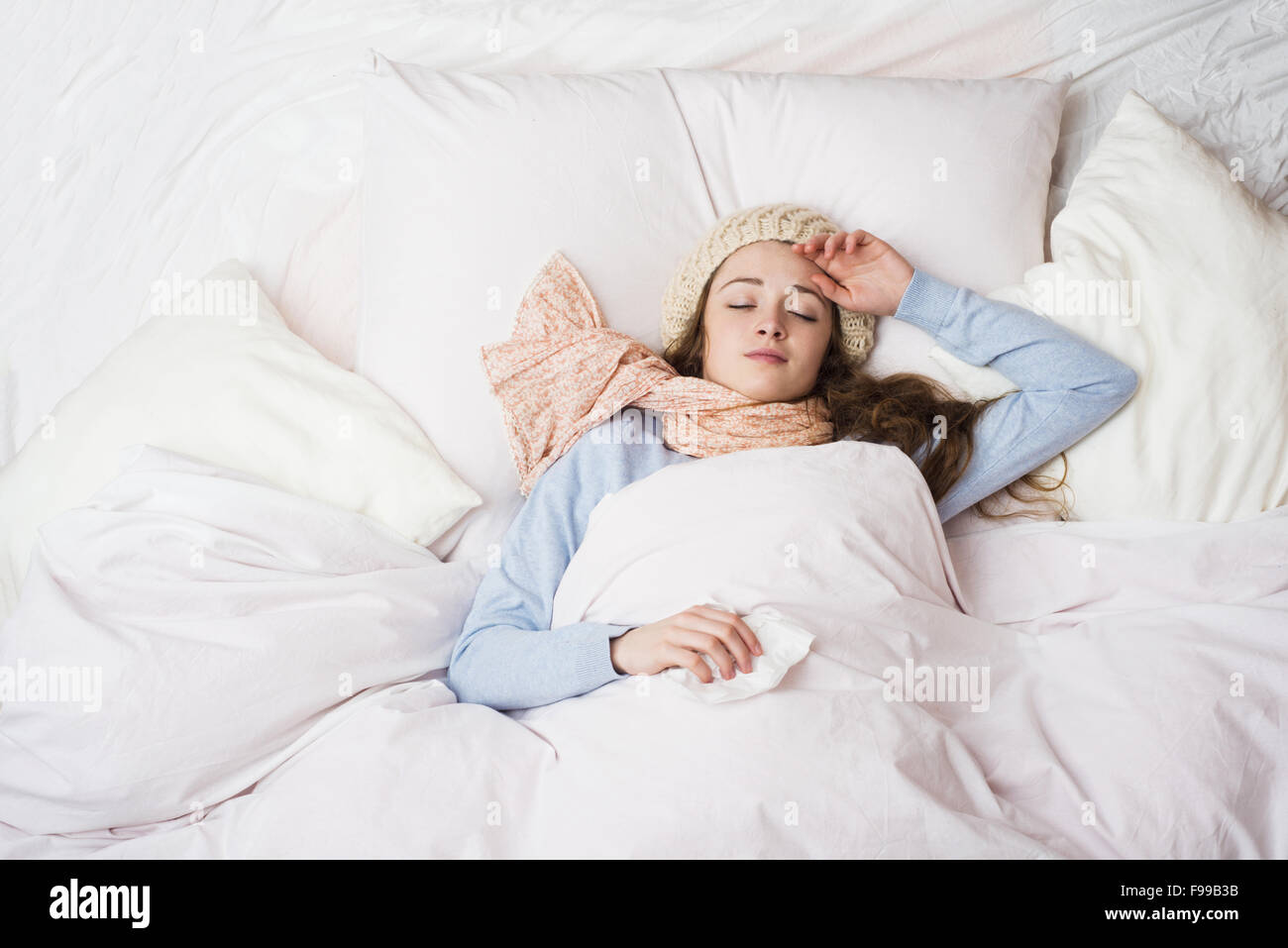 Sick woman lying in bed with high fever. She has cold and flu Stock ...