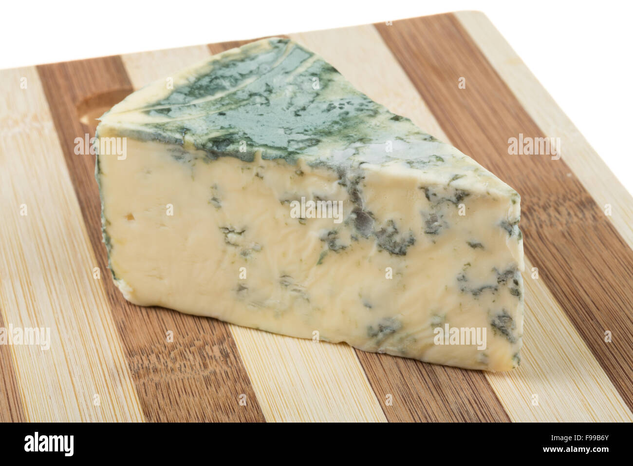 Wedge of soft blue cheese, isolated on white Stock Photo - Alamy