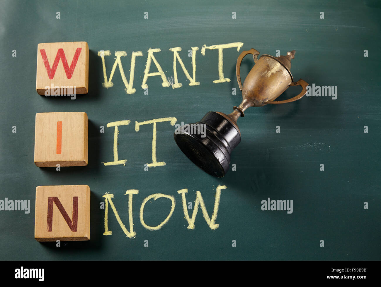 Hand writing WIN- Want it now written with chalk on blackboard Stock ...