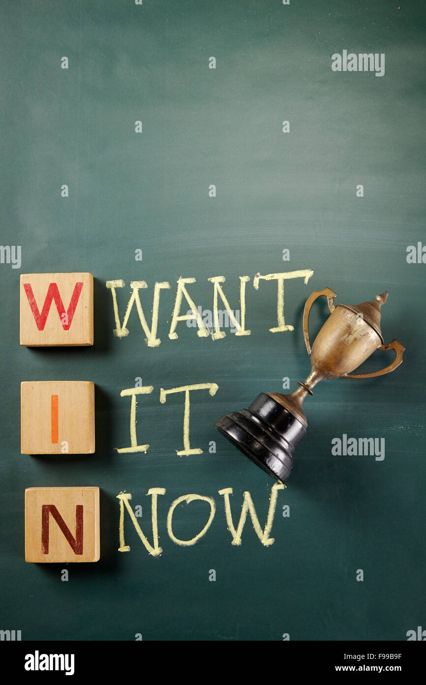 Hand writing WIN- Want it now written with chalk on blackboard Stock ...