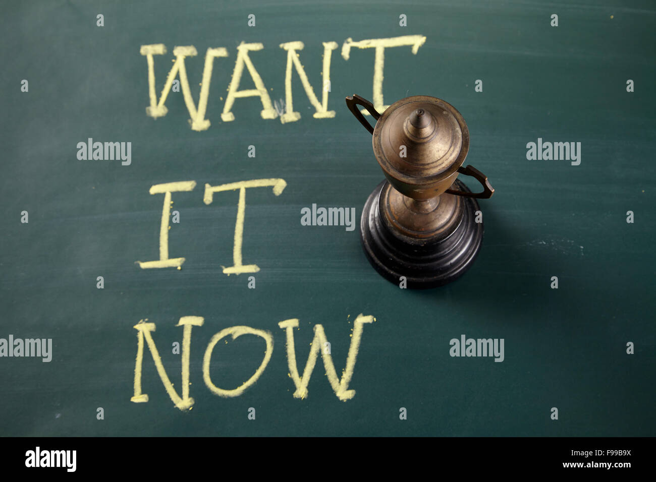 Hand writing WIN- Want it now written with chalk on blackboard Stock ...