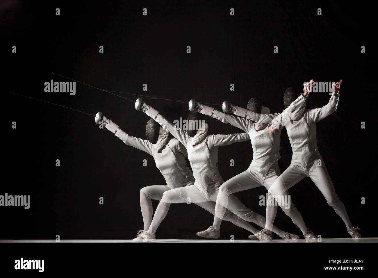 Full-length portrait of woman wearing white fencing costume on black ...