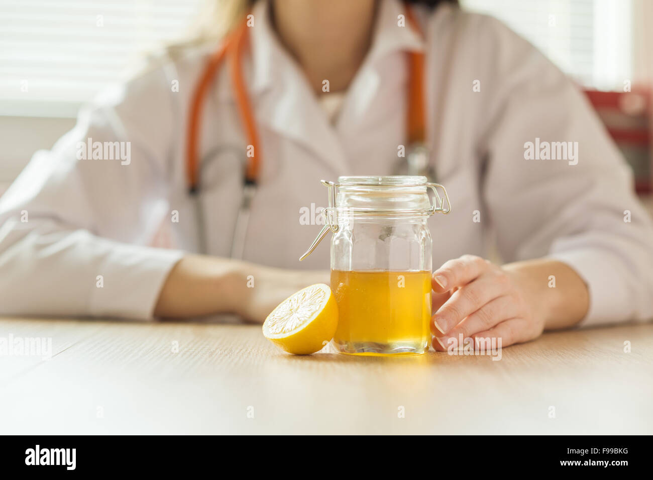 Detail of honey and lemon with doctor woman in background Stock Photo ...