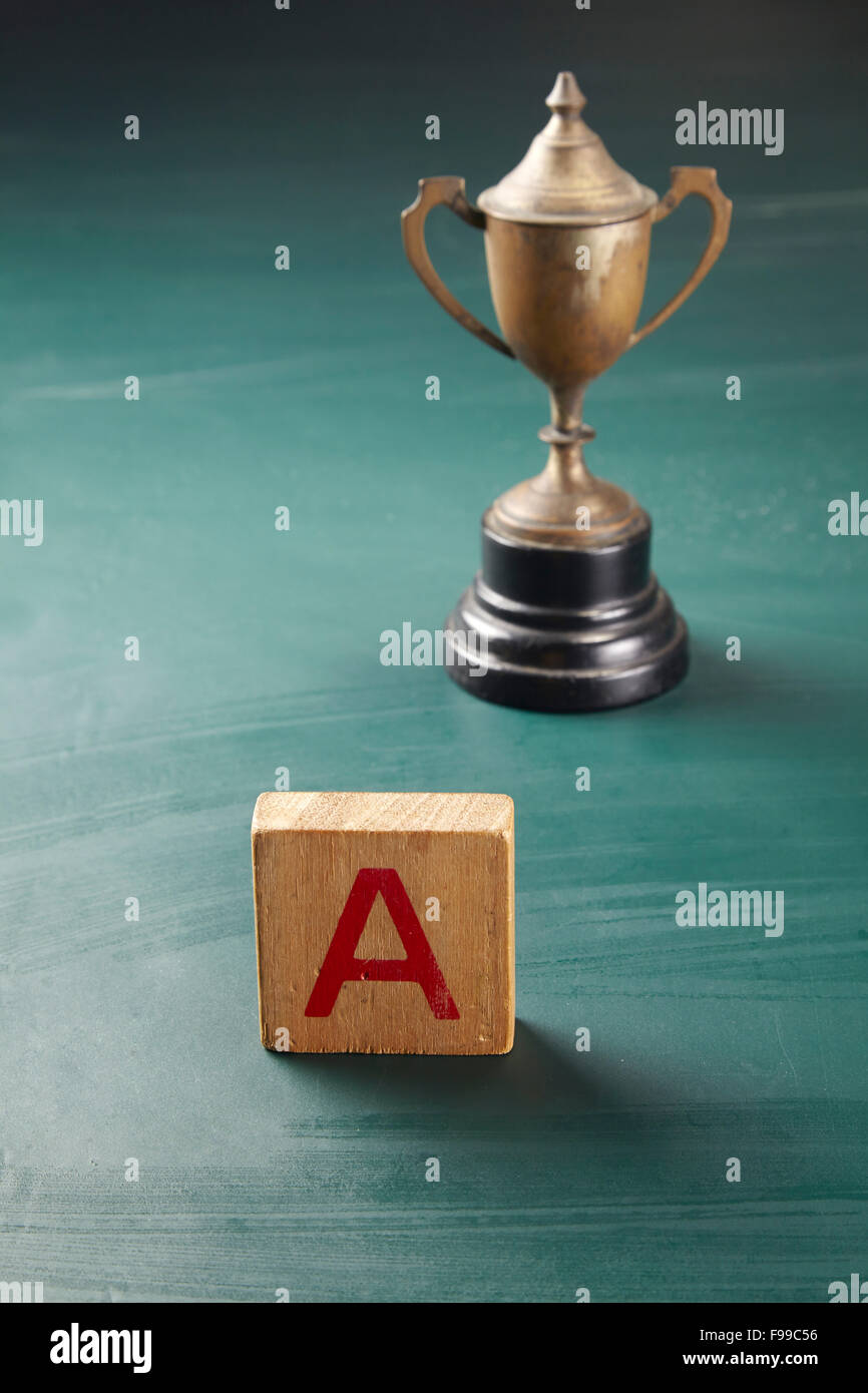 wood block with alphabet A and trophy on the blackboard Stock Photo - Alamy