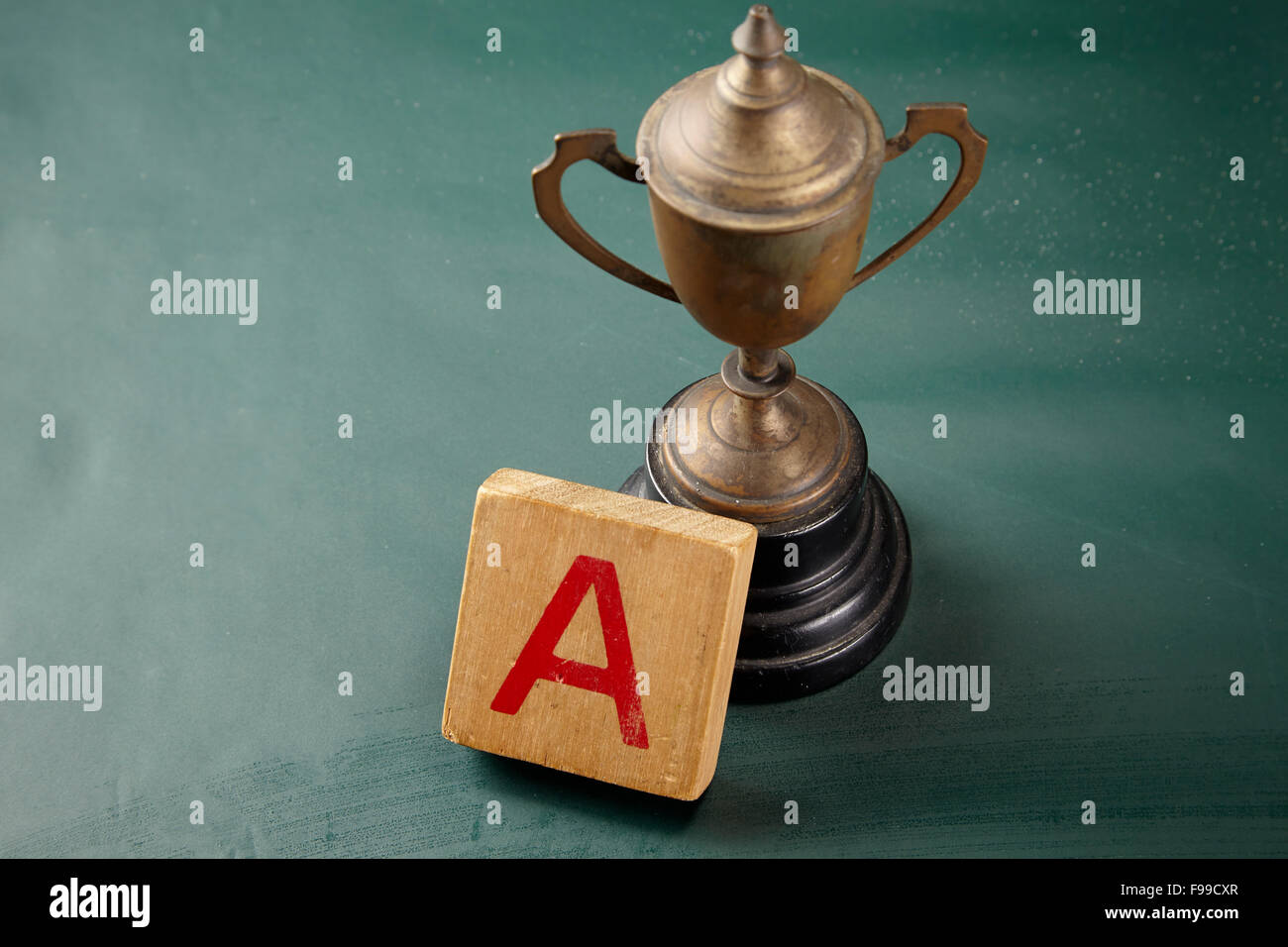 wood block with alphabet A and trophy on the blackboard Stock Photo - Alamy