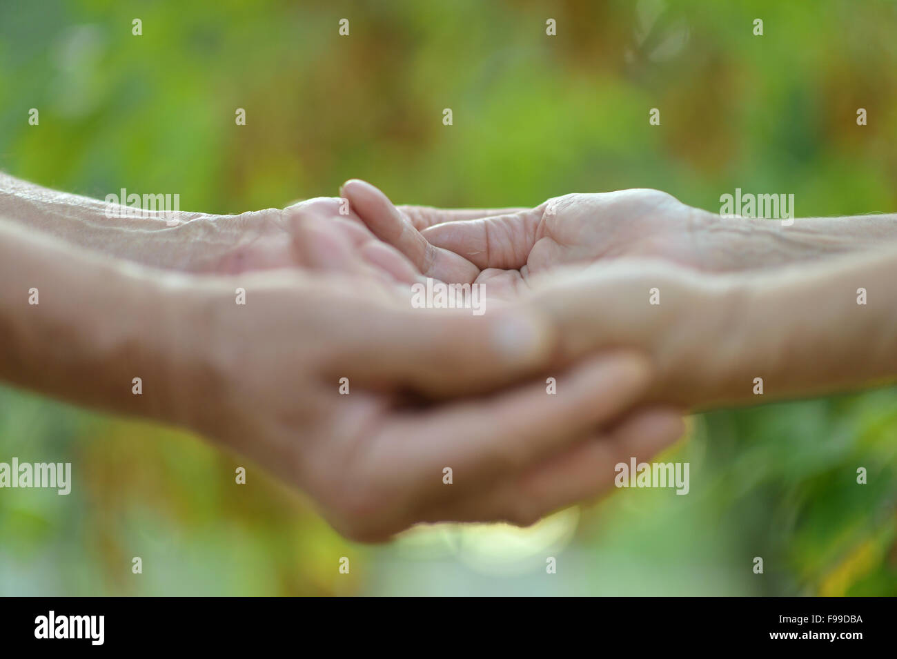 Elderly couple holding hands Stock Photo - Alamy