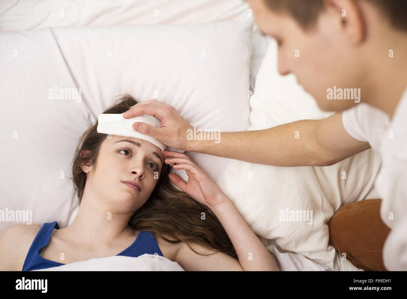 Sick woman is lying in bed. She has cold, flu and high fever Stock ...