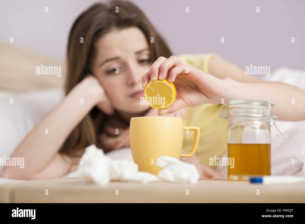 Sick woman lying in bed with high fever. She has cold and flu. She is ...