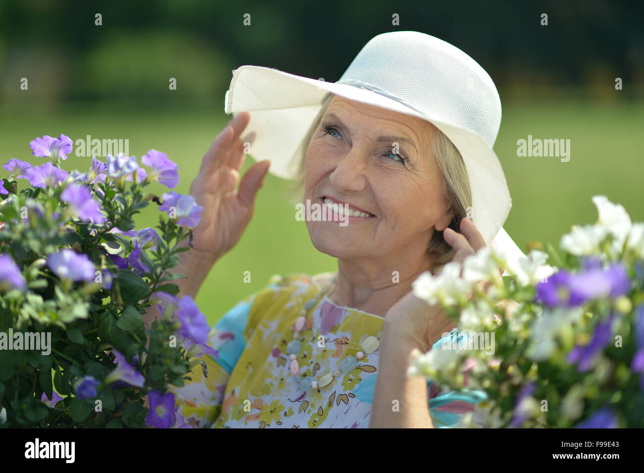 Older woman with flowers Stock Photo - Alamy