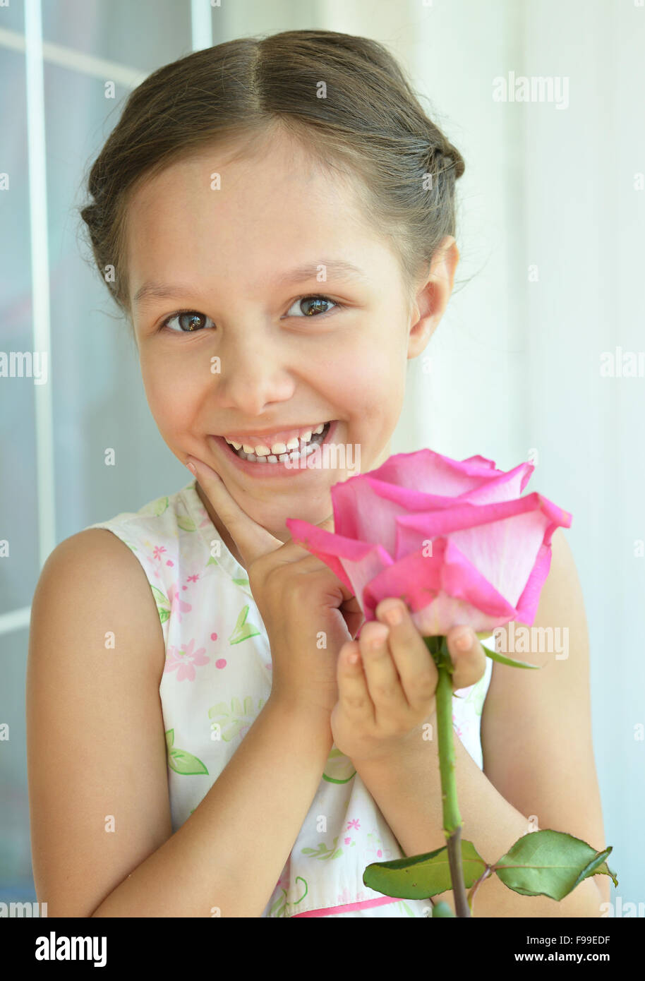 Little girl with rose flower Stock Photo - Alamy