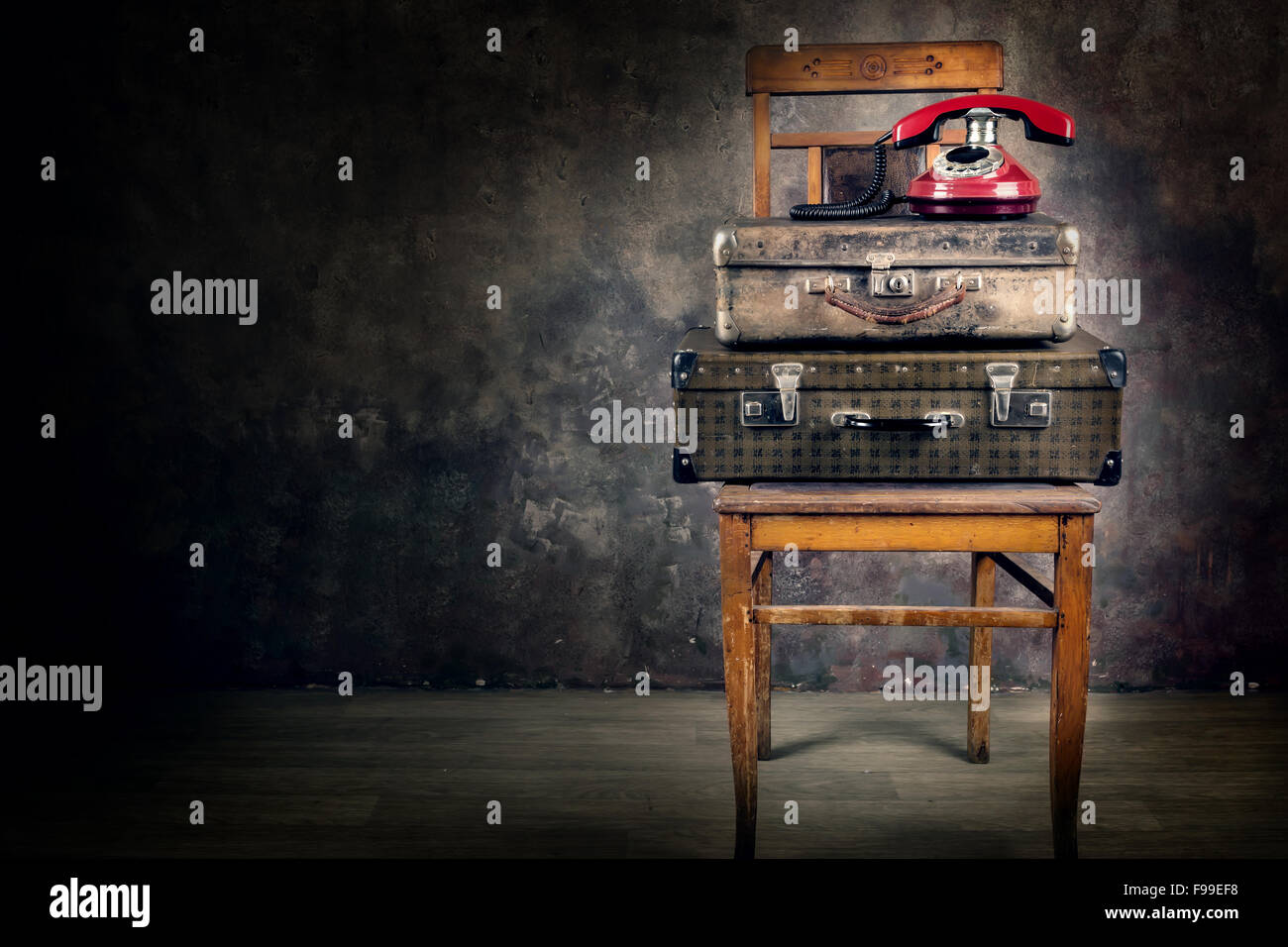 Vintage suitcase with phone on chair Stock Photo - Alamy