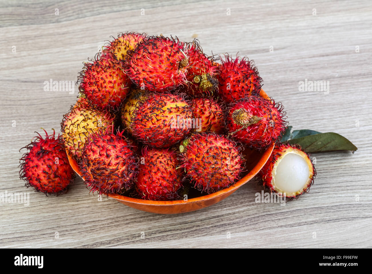 Asian fruit - rambutan - on the wood background Stock Photo - Alamy