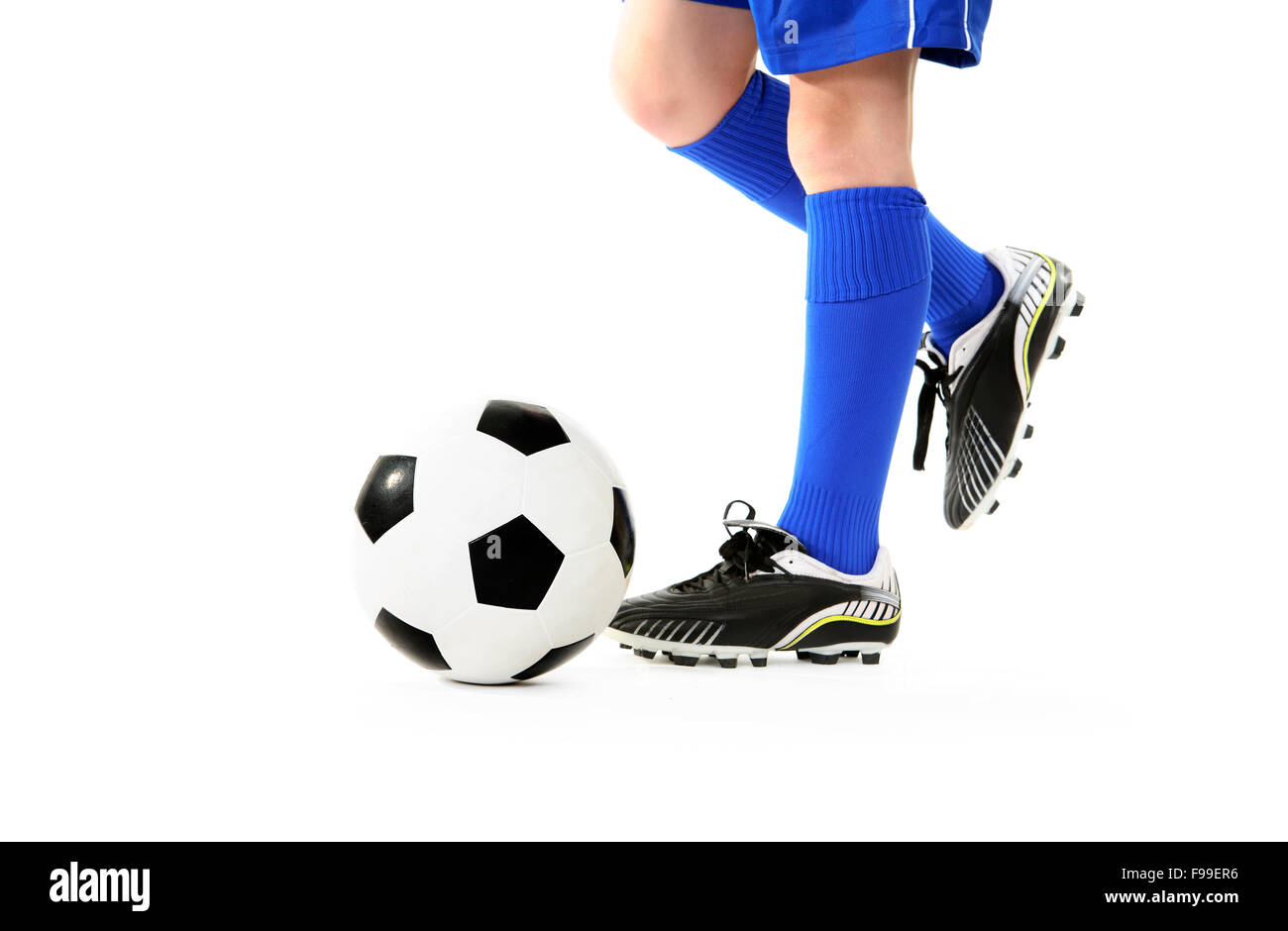 Boy kicking soccer ball Stock Photo - Alamy