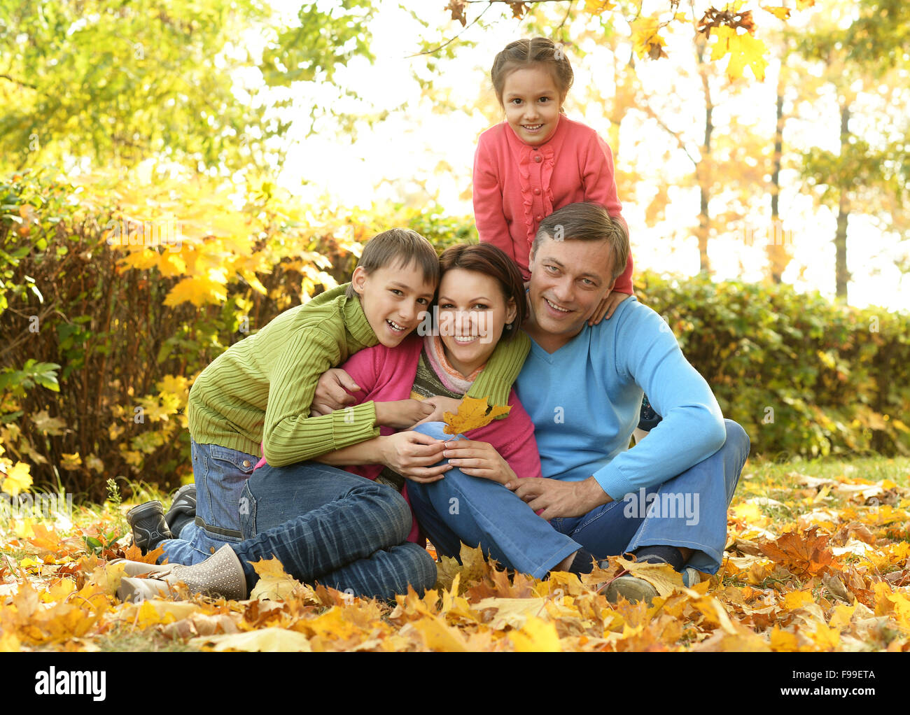 Family in autumn park Stock Photo - Alamy