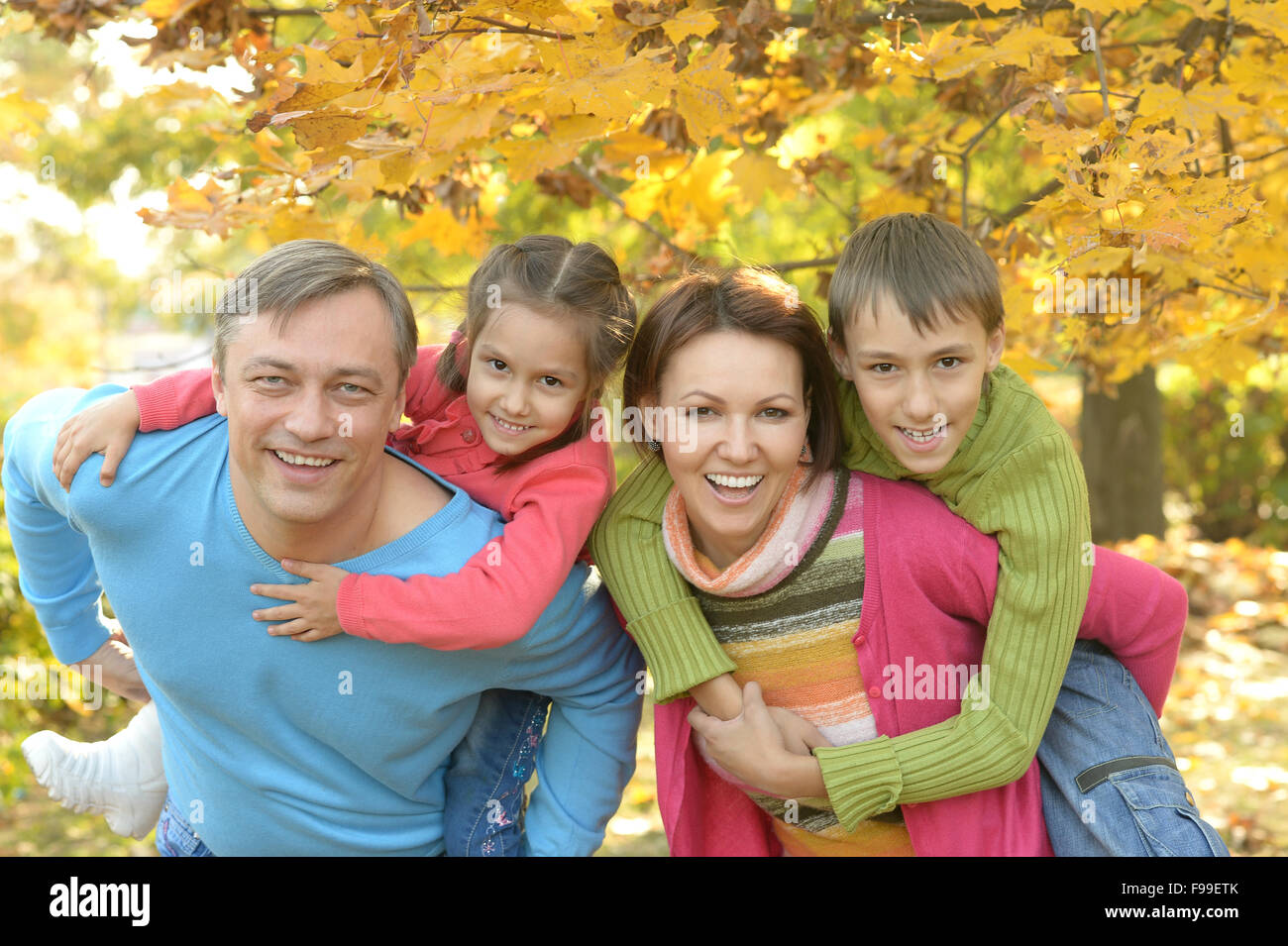 Family in autumn park Stock Photo - Alamy