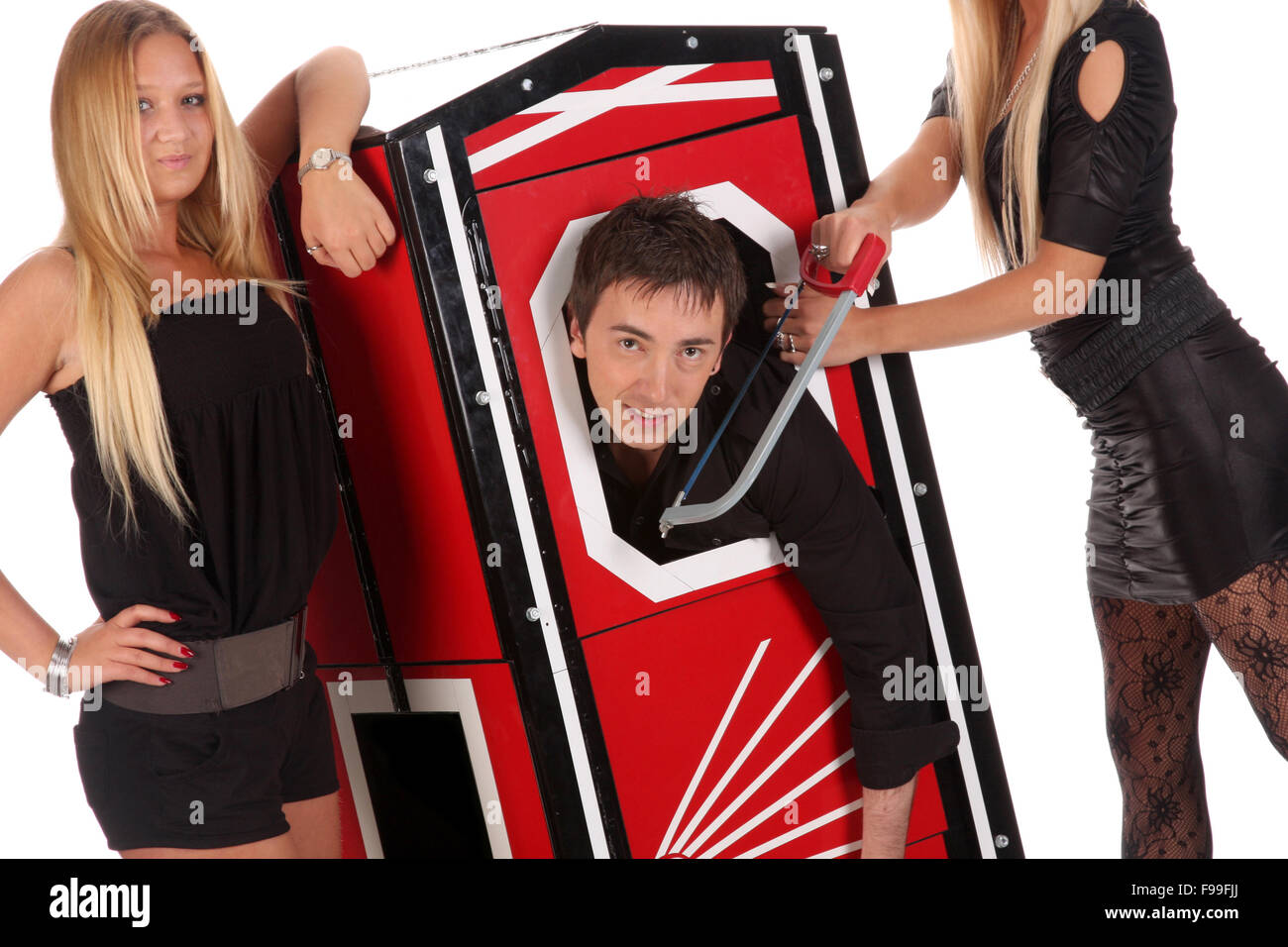 Magician performance and two beauty girls in a magic box with ha Stock ...