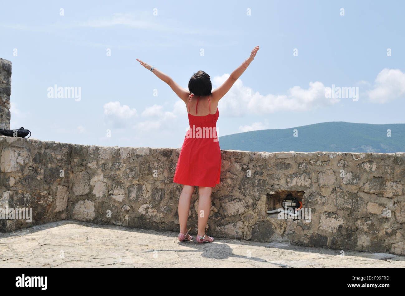 young happy woman with arms wide open representing freedom concept ...