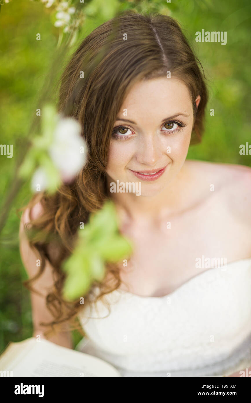 Beautiful woman with flowers in spring sunshine Stock Photo - Alamy