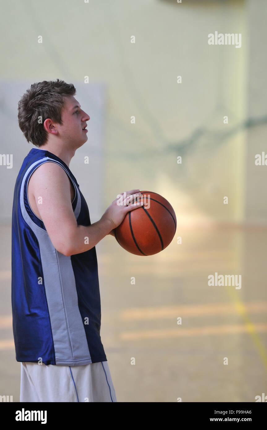 one healthy young man play basketball game in school gym indoor Stock ...