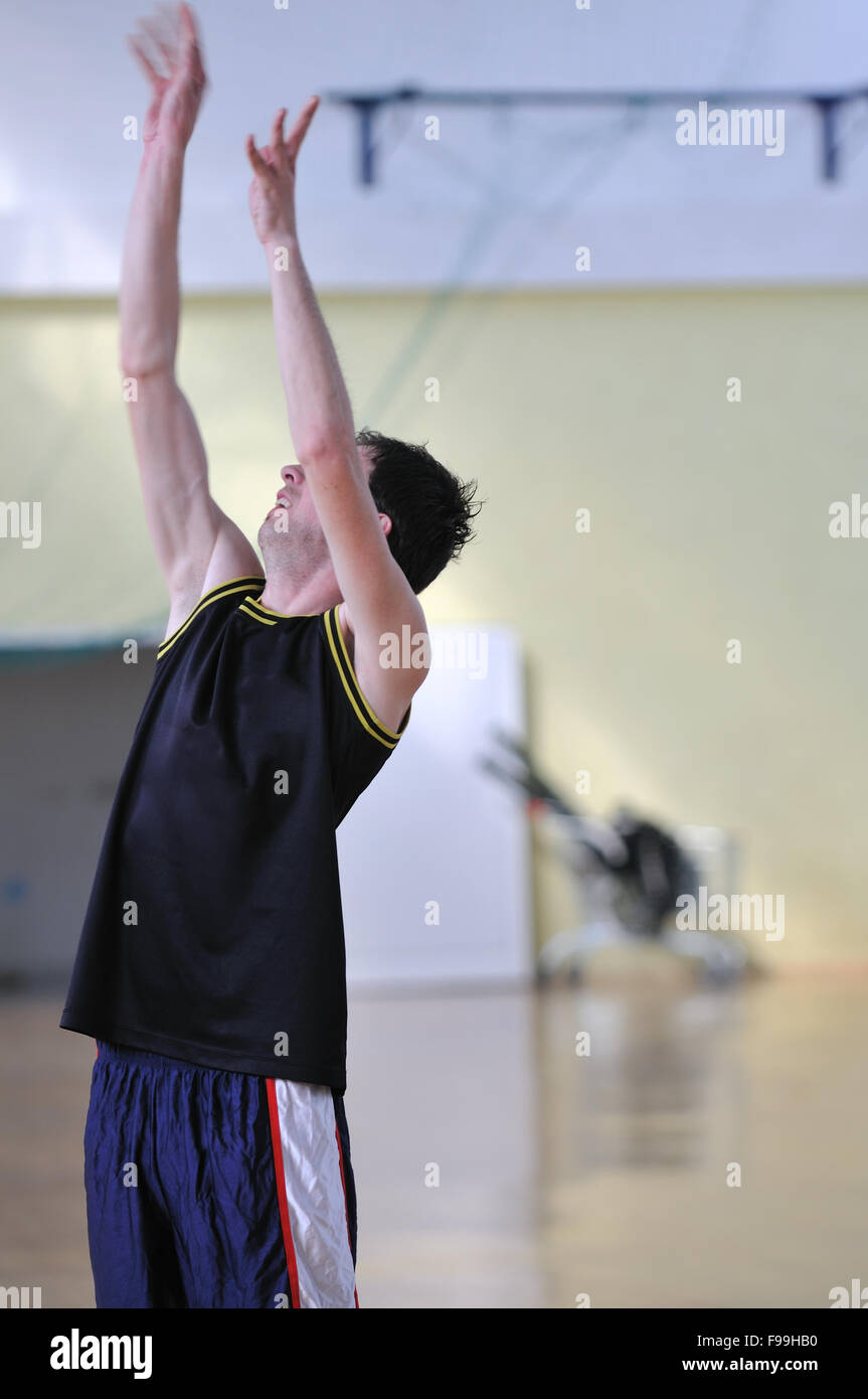 one healthy young man play basketball game in school gym indoor Stock ...