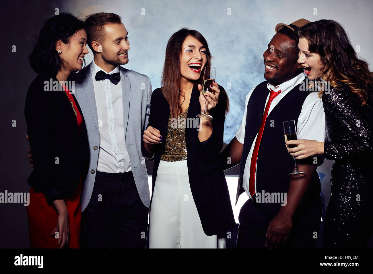 Happy young people in smart clothes enjoying party Stock Photo - Alamy