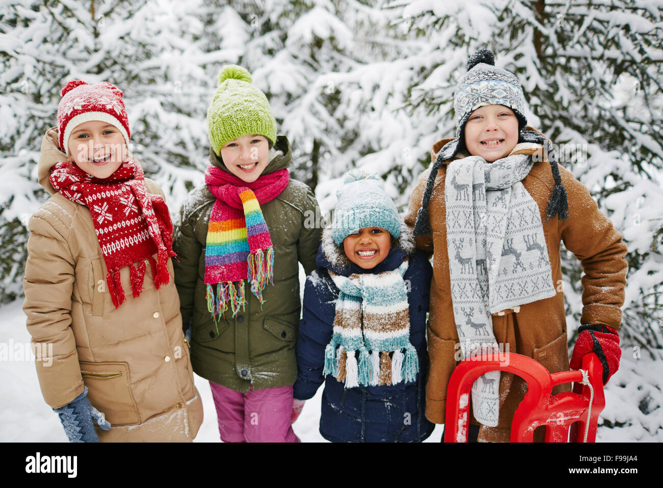Cheerful kids spending leisure in winter forest Stock Photo - Alamy