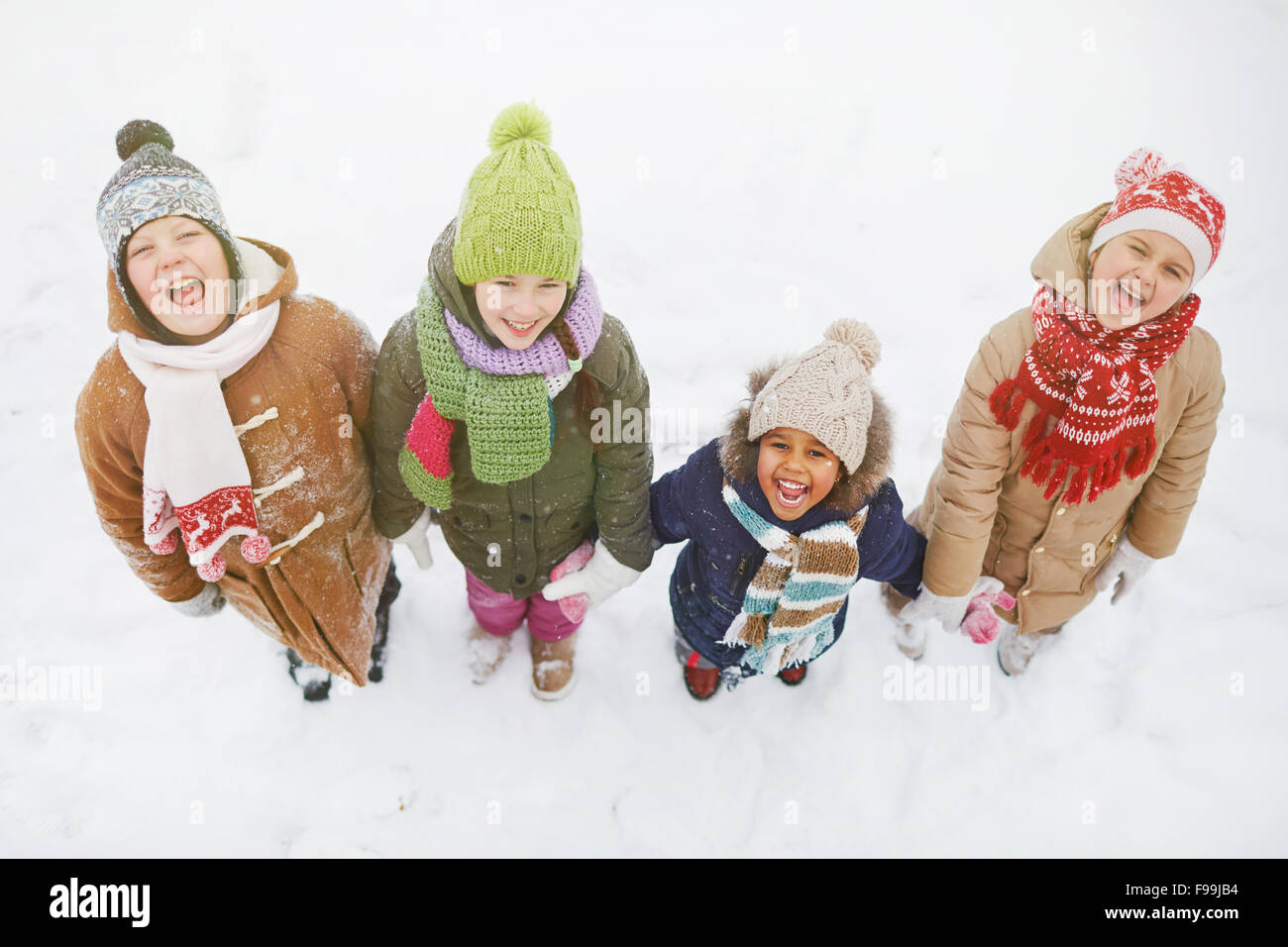 Joyful children in winter-wear looking at camera Stock Photo - Alamy