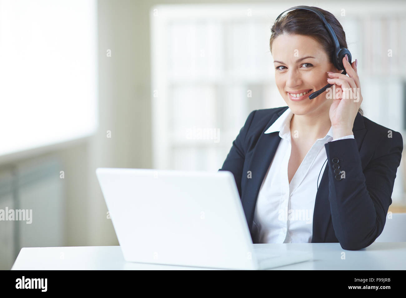 Pretty young operator looking at camera Stock Photo - Alamy