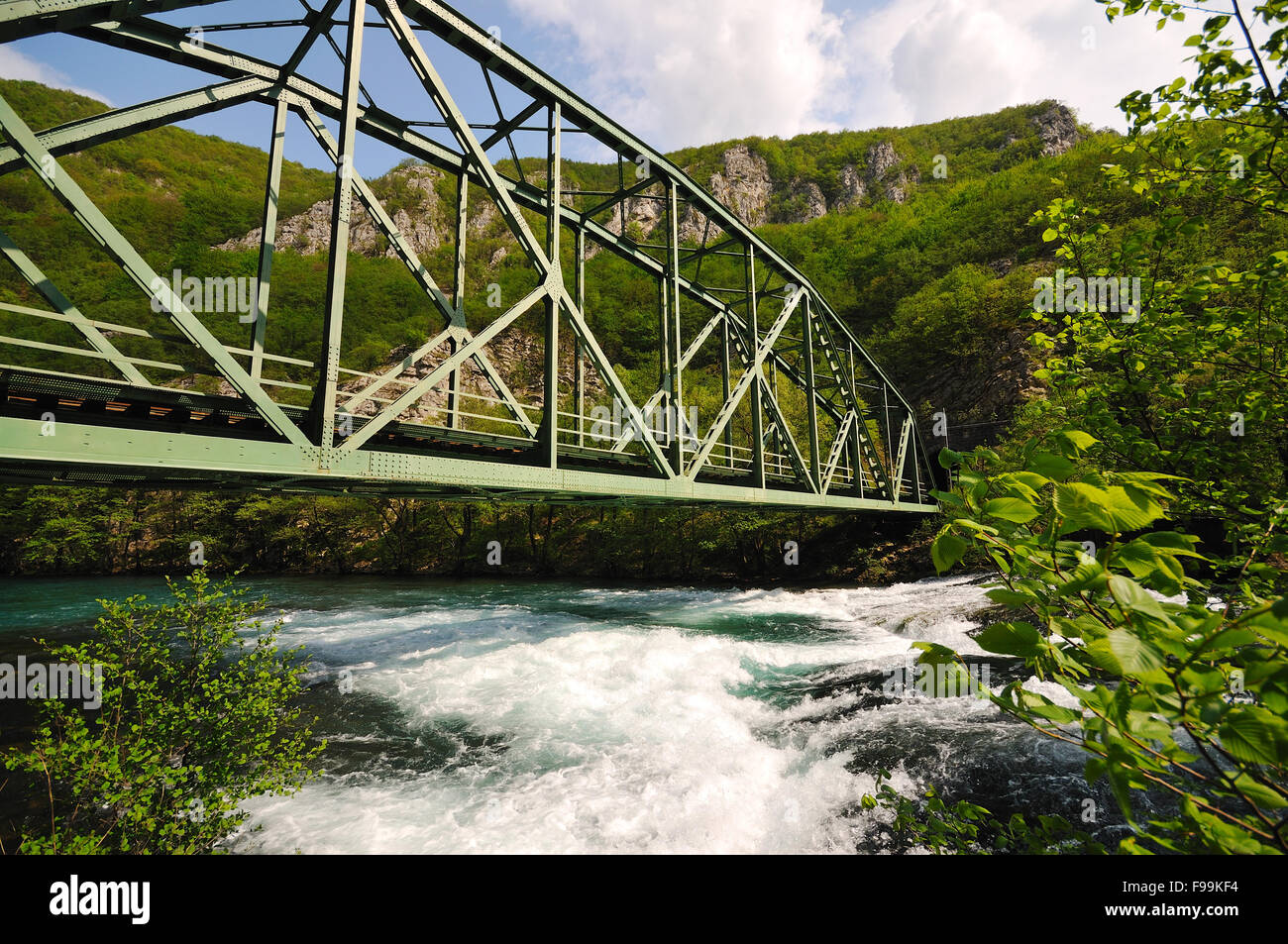 beautiful bridge in nature over wild river Stock Photo - Alamy