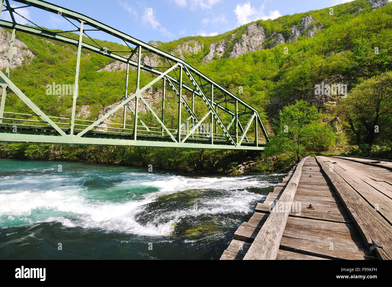 beautiful bridge in nature over wild river Stock Photo - Alamy