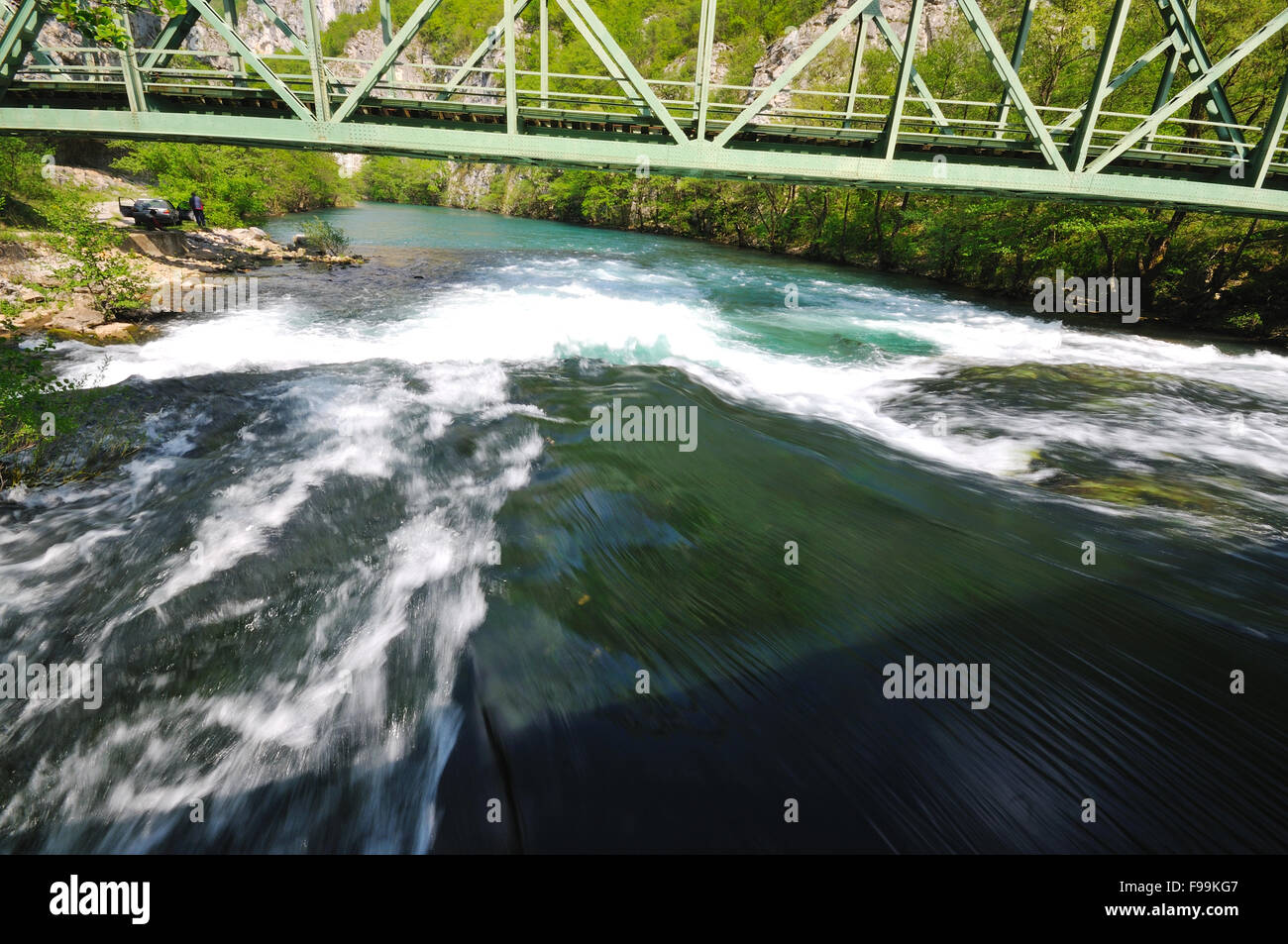 beautiful bridge in nature over wild river Stock Photo - Alamy