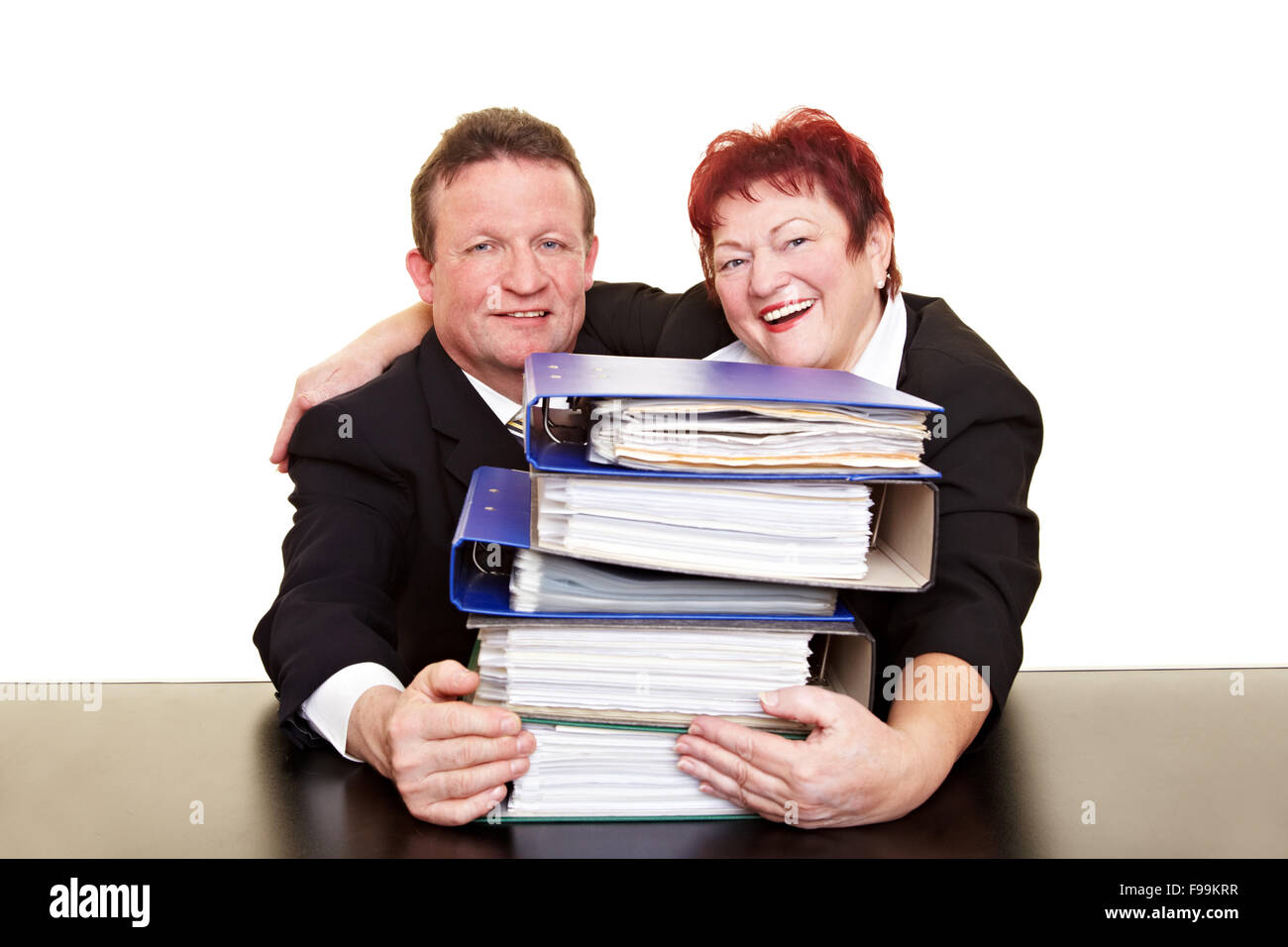 Two happy senior business people with a stack of files Stock Photo - Alamy