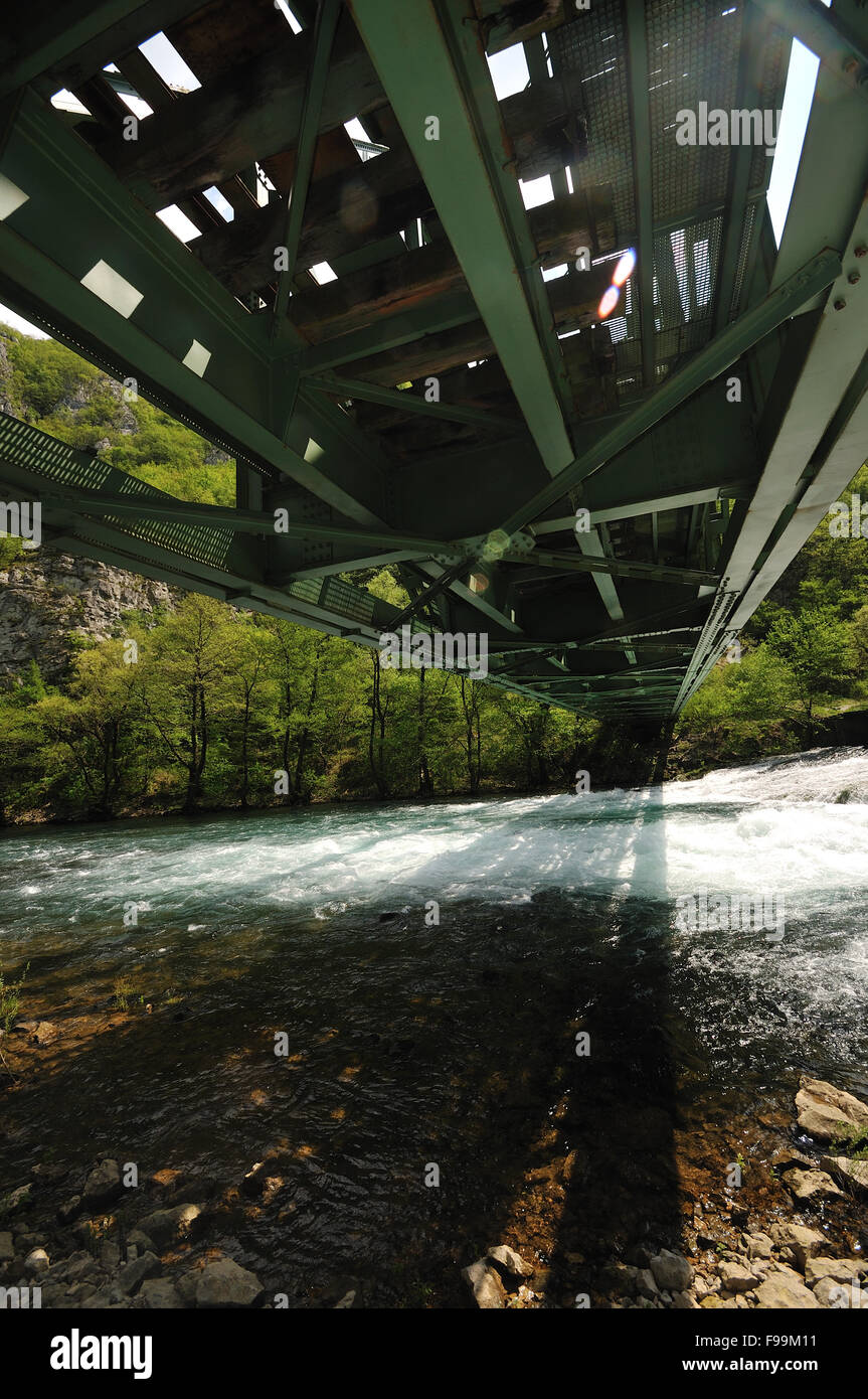 beautiful bridge in nature over wild river Stock Photo - Alamy