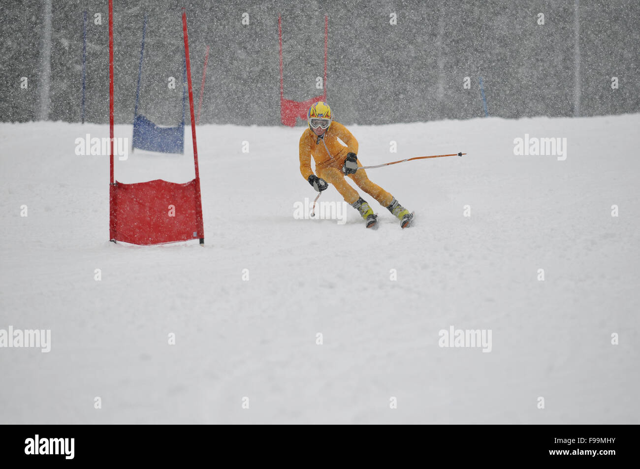 young skier race fast downhil at winter snow scene Stock Photo - Alamy