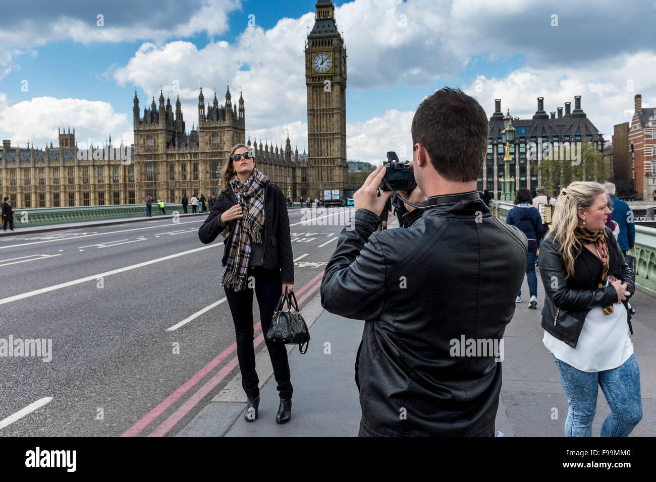Young male taking photos of attractive female in front of House of ...
