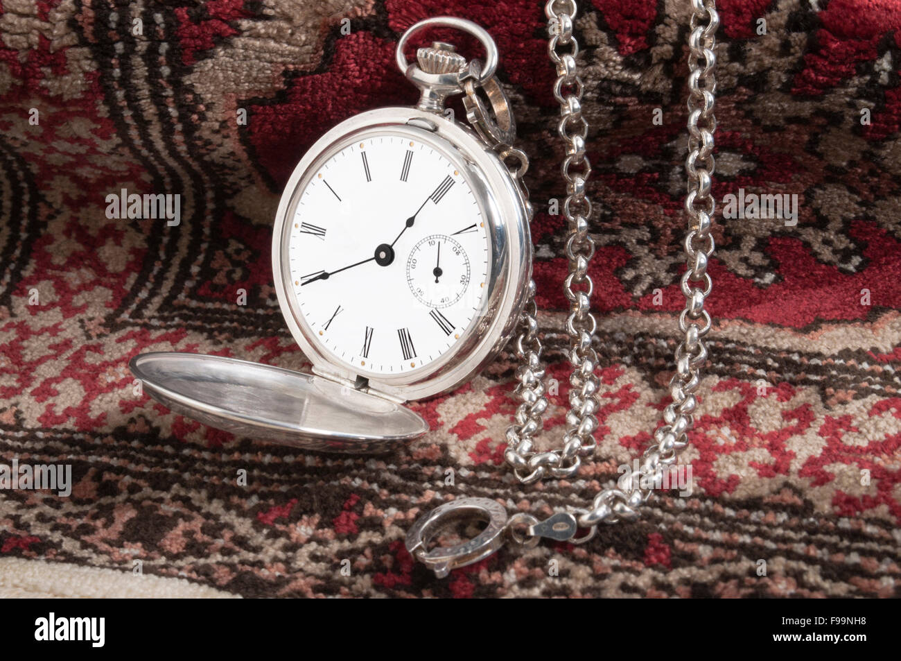 Silver pocket watch on carpet Stock Photo - Alamy