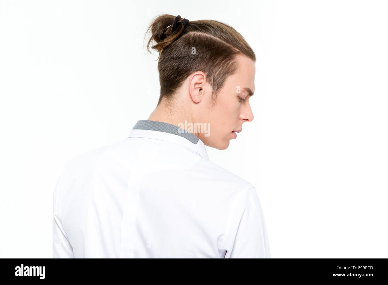 Back view portrait of a young man standing isolated on a white ...