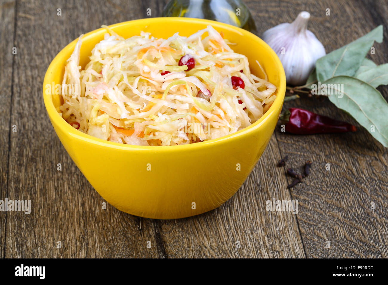 Fermented cabbage - Sauerkraut with herbs and spices on the wood ...