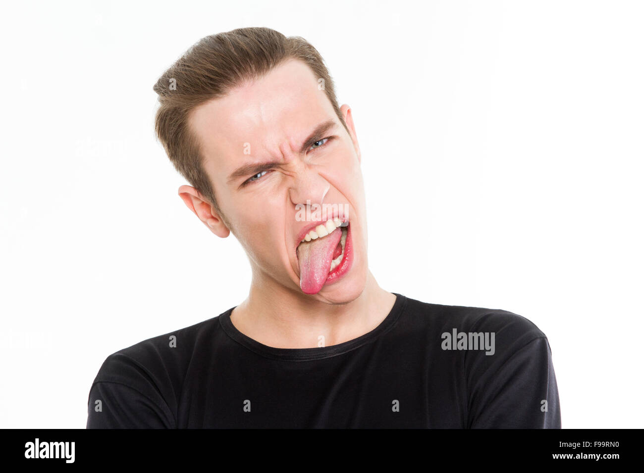 Portrait of a young man showing his tongue isolated on a white ...