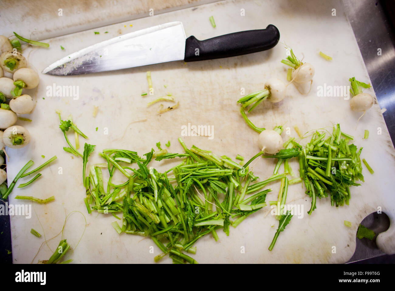 Cutting board, knife and chopped turnips detail Stock Photo - Alamy
