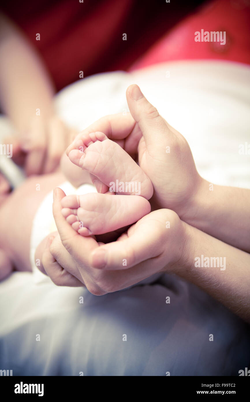 Baby foot in hands Stock Photo - Alamy