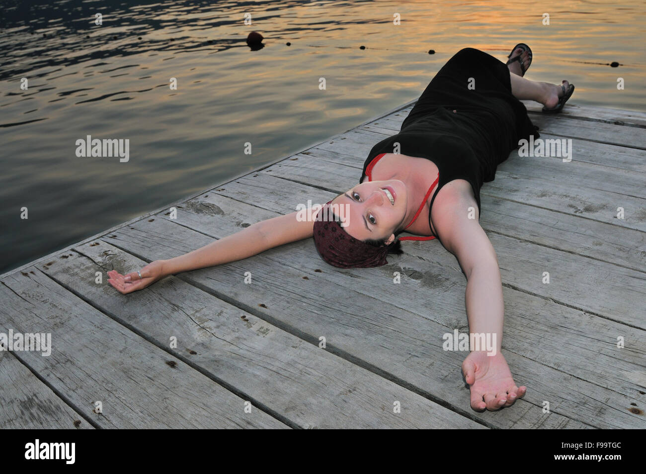young happy woman with arms wide open representing freedom concept ...