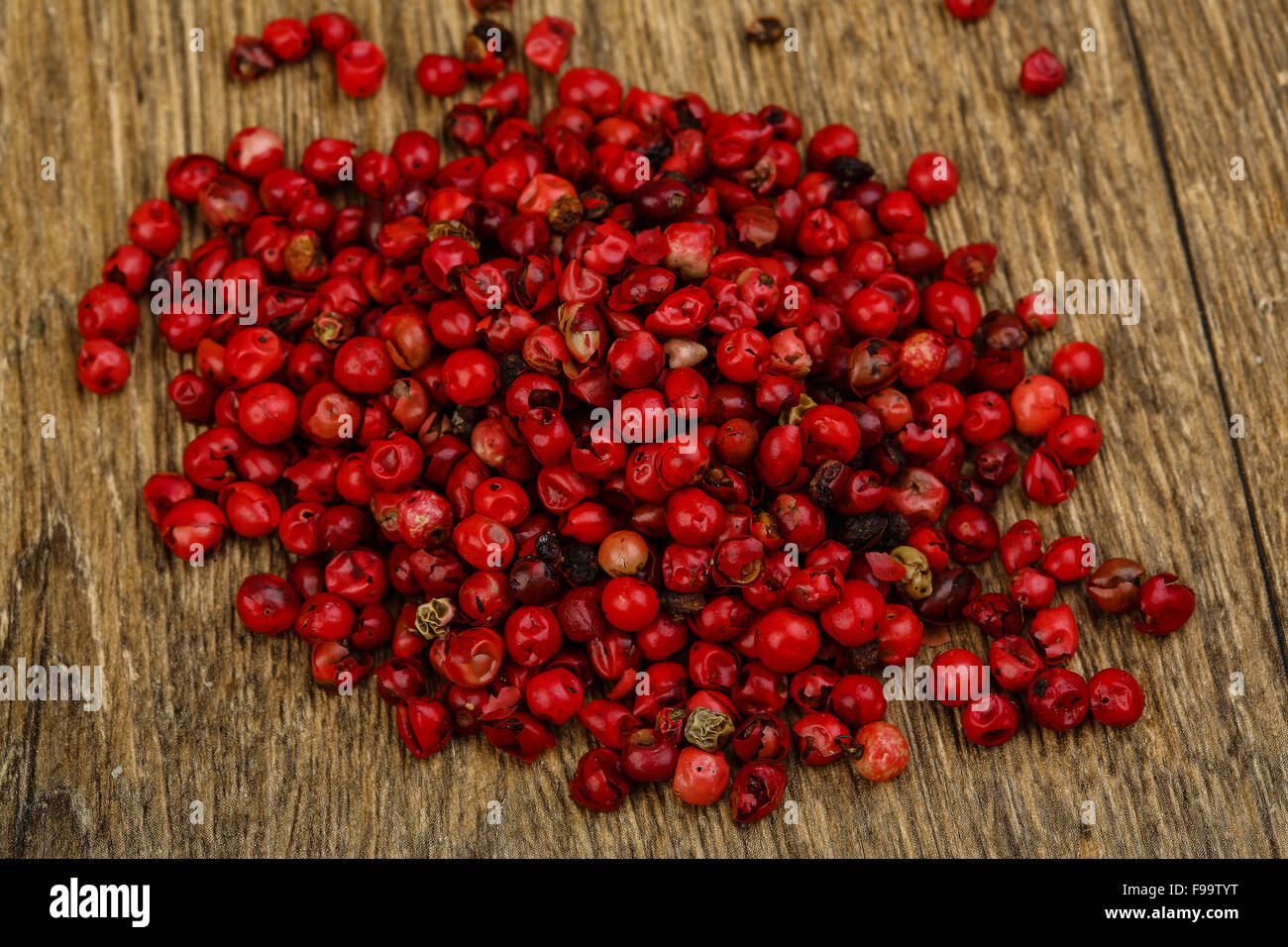 Dry Rose pepper corn on the wood background Stock Photo - Alamy
