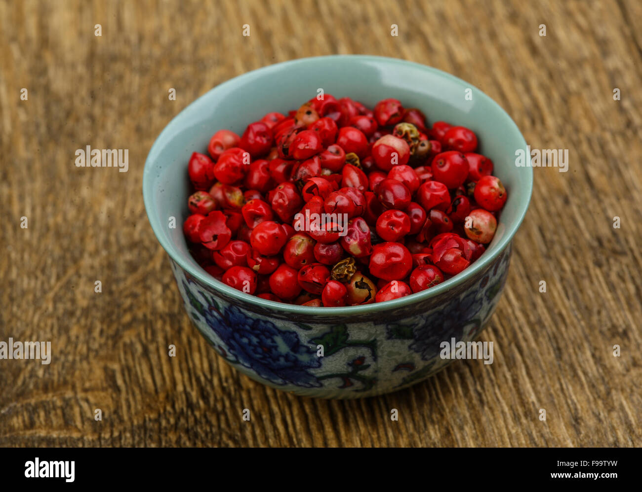 Dry Rose pepper corn on the wood background Stock Photo - Alamy
