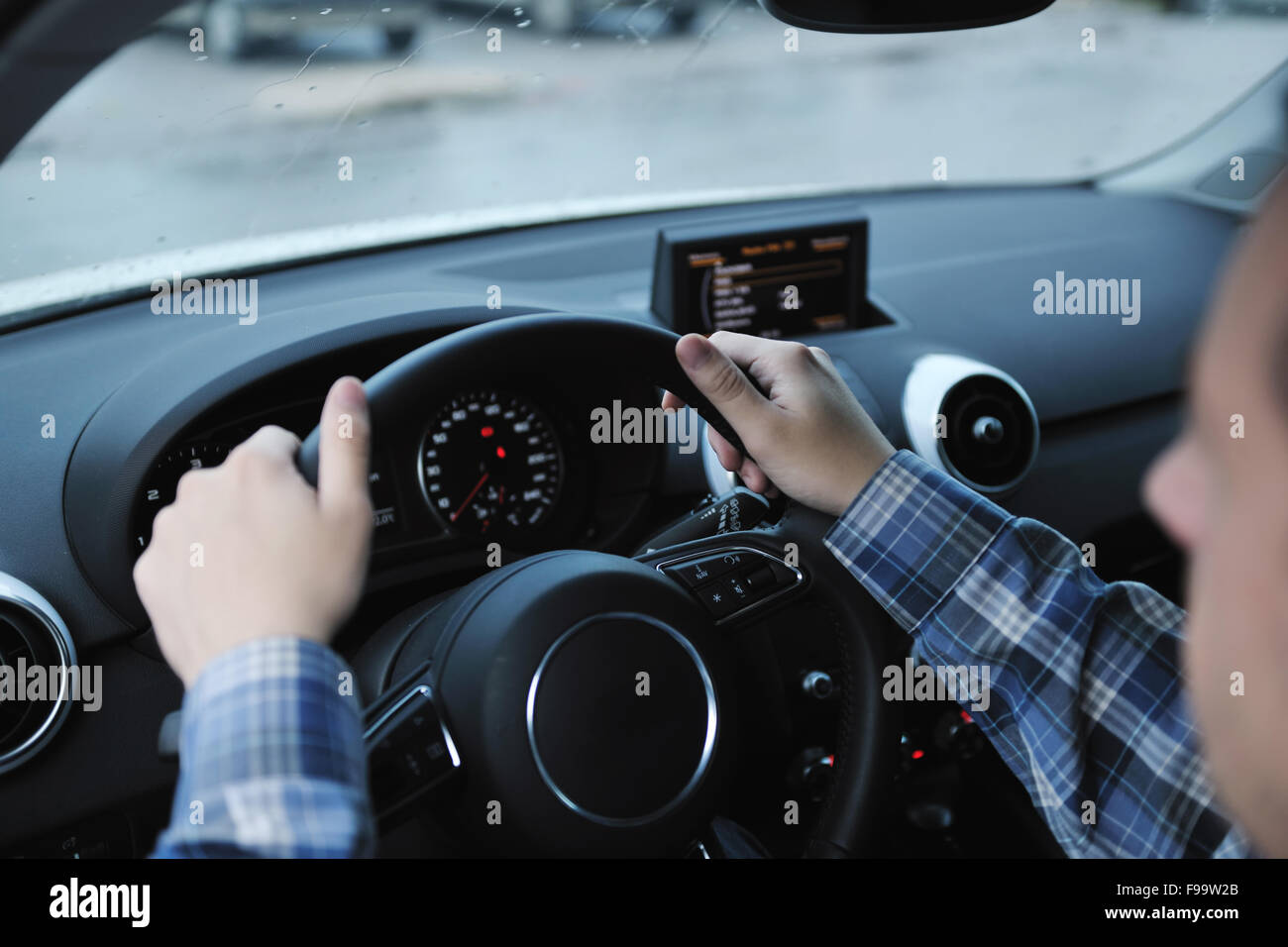 young man using new car navigation and onboard vehicle transport system ...