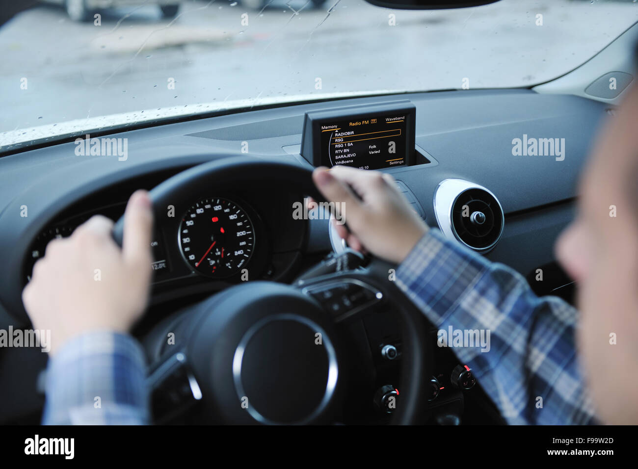 young man using new car navigation and onboard vehicle transport system ...