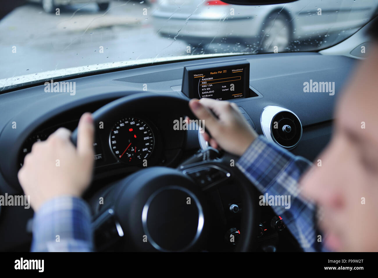 young man using new car navigation and onboard vehicle transport system ...