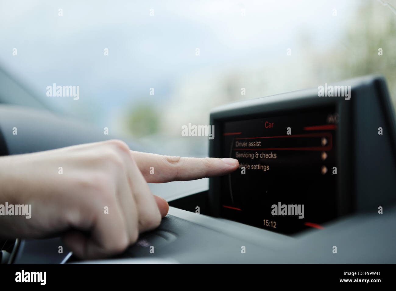 young man using new car navigation and onboard vehicle transport system ...